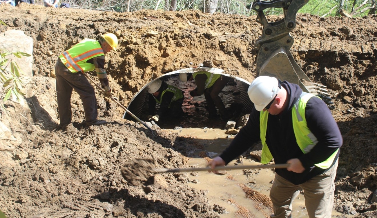 Culvert restoration w men working | FWS.gov