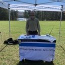 Motor Vehicle Operator Charles Hood manning booth | FWS.gov