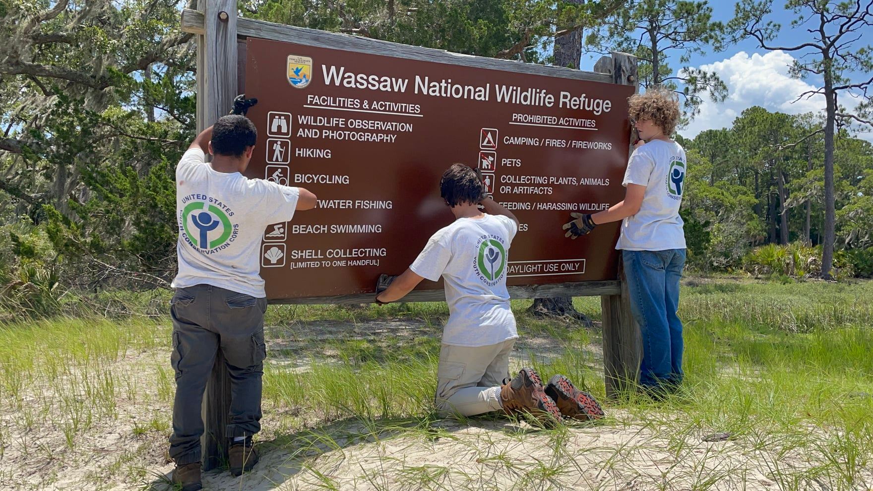 Savannah Coastal YCC group insetting new signage | FWS.gov