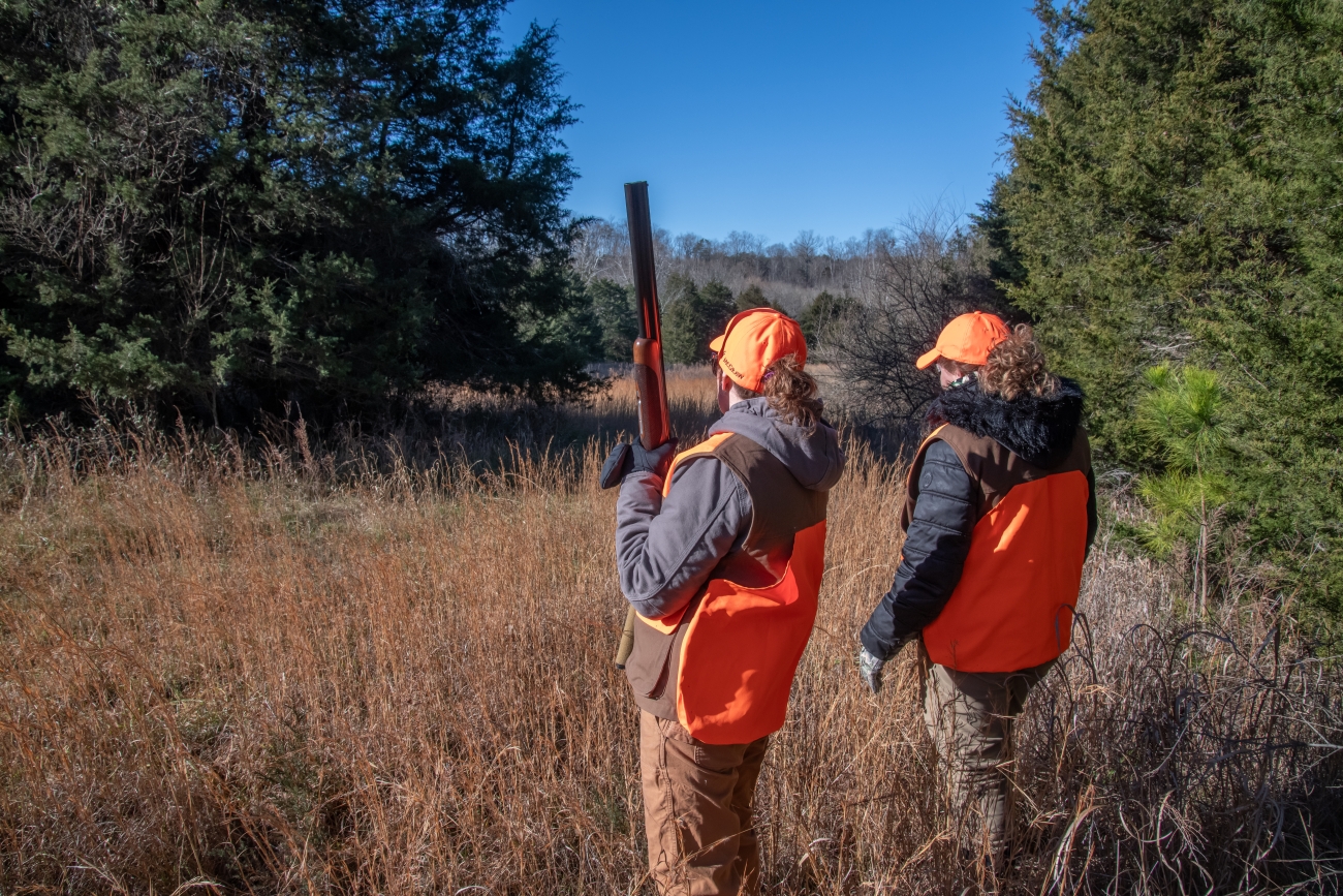 Two women upland hunting in fall field with shotgun | FWS.gov