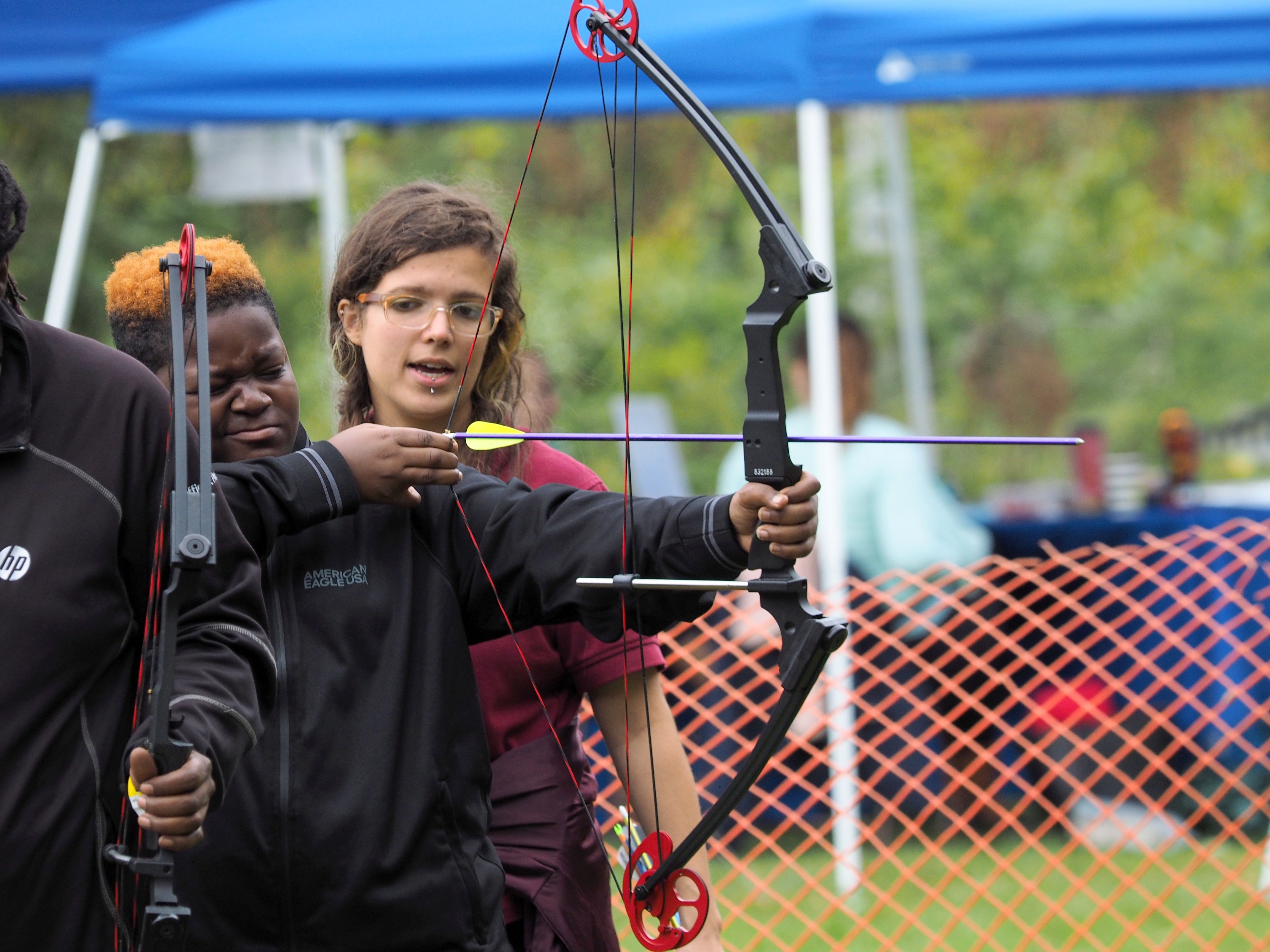 FWS intern coaches student in archery at John Heinz NWR | FWS.gov
