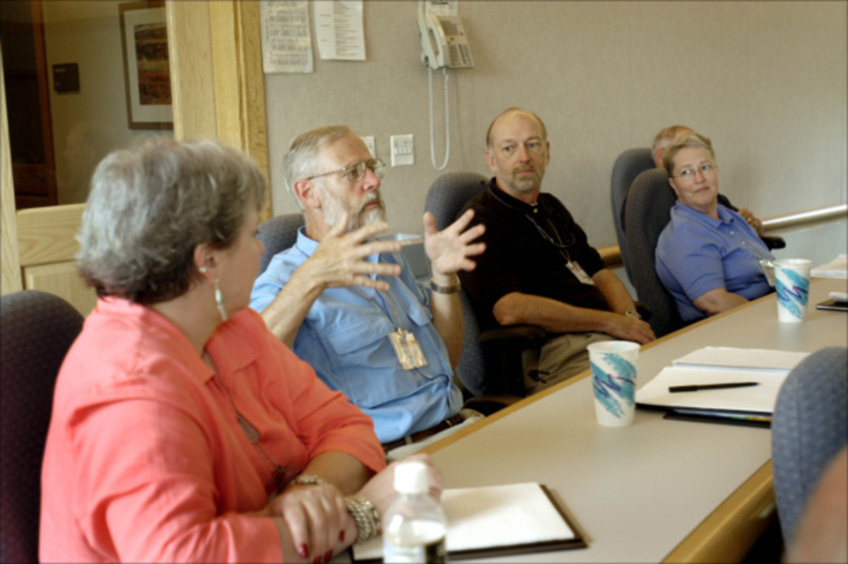 People participating in discussion during meeting held at the National ...