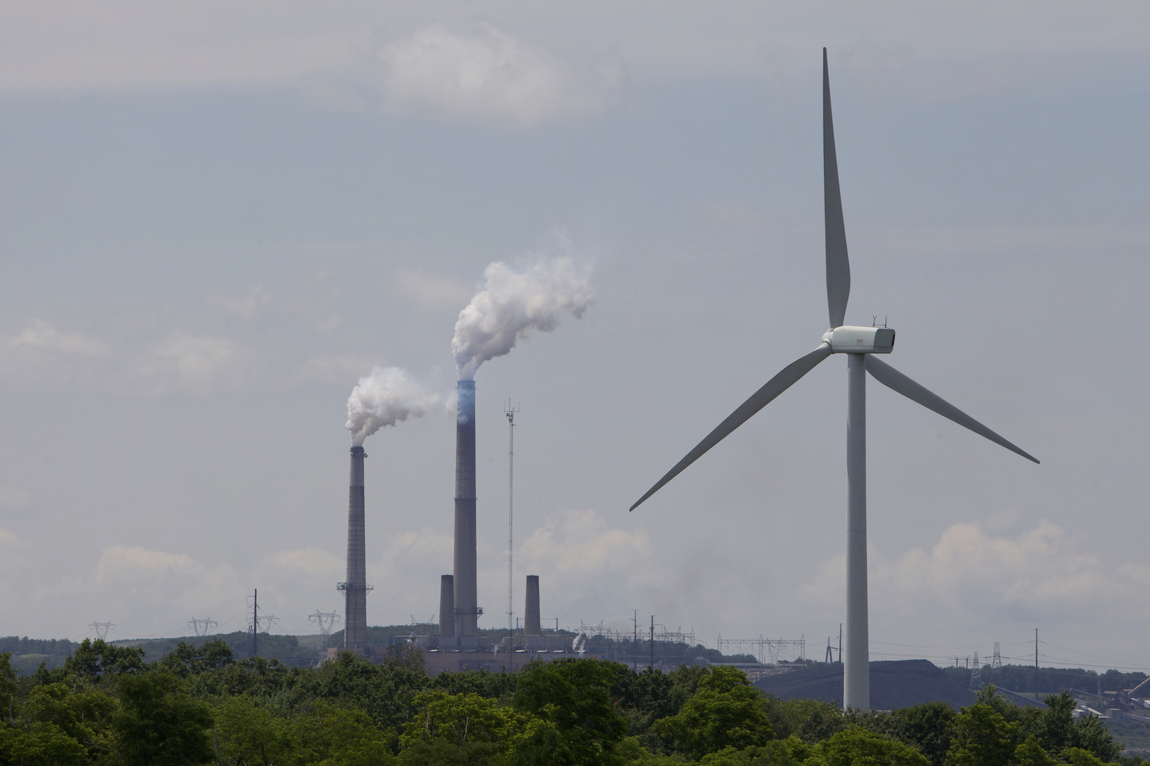 Wind energy turbine and coal power smoke stacks | FWS.gov
