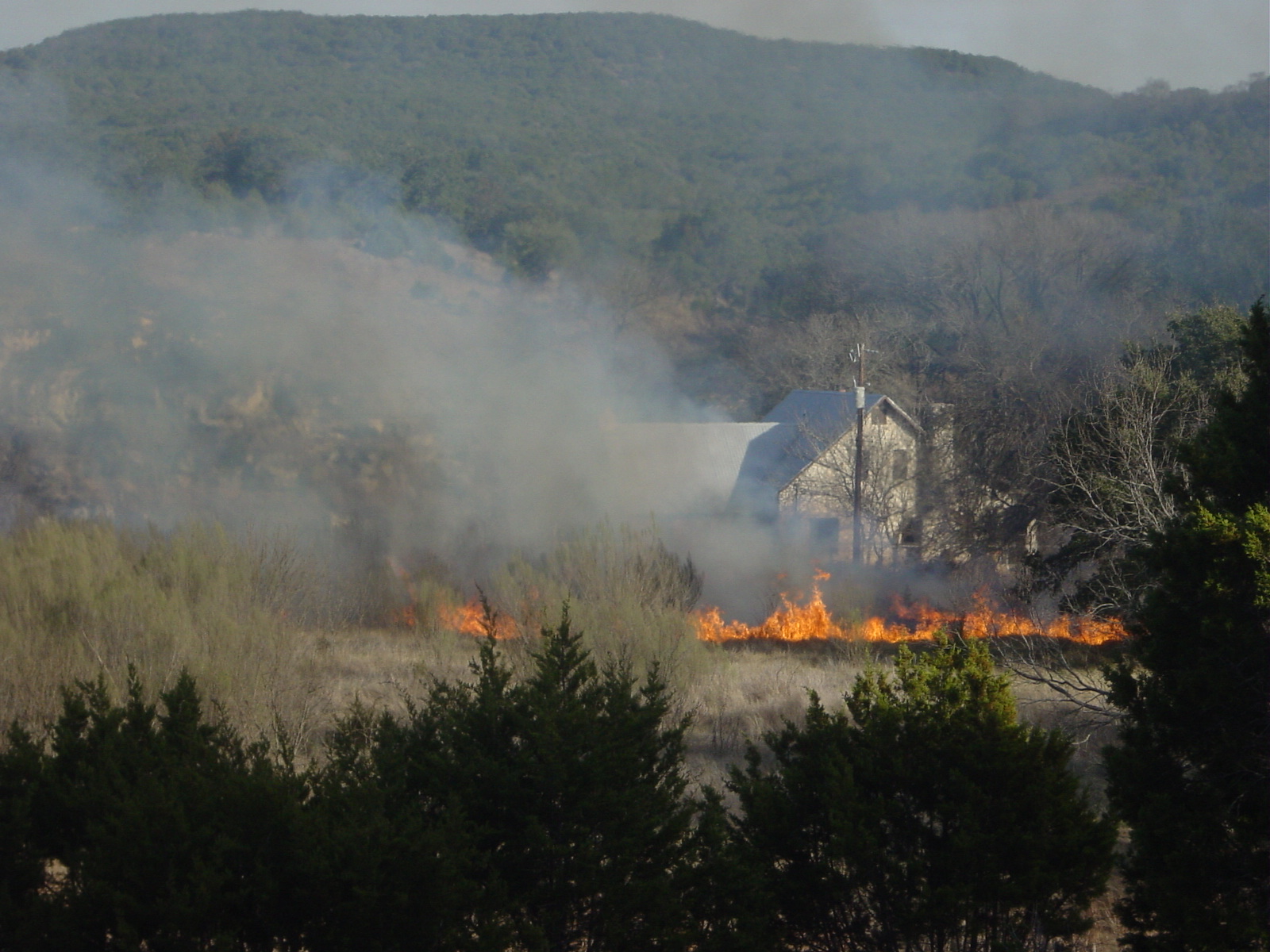 Prescribed fire with house | FWS.gov