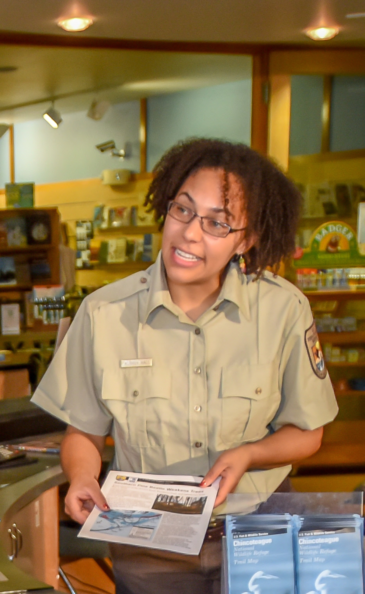 Fish and Wildlife Service staff greets visitors at visitor center desk ...