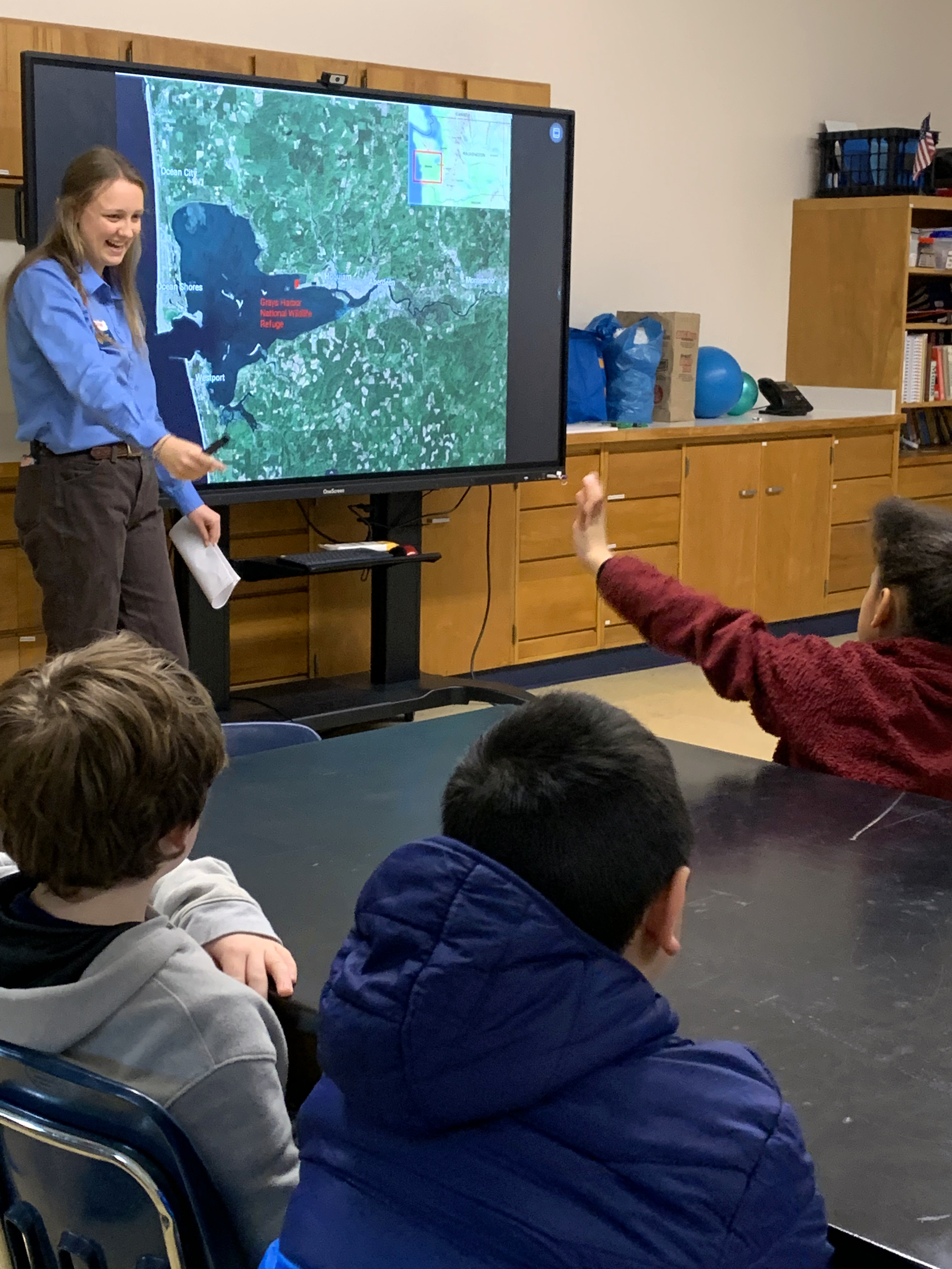 An AmeriCorps member works with students in a classroom. | FWS.gov
