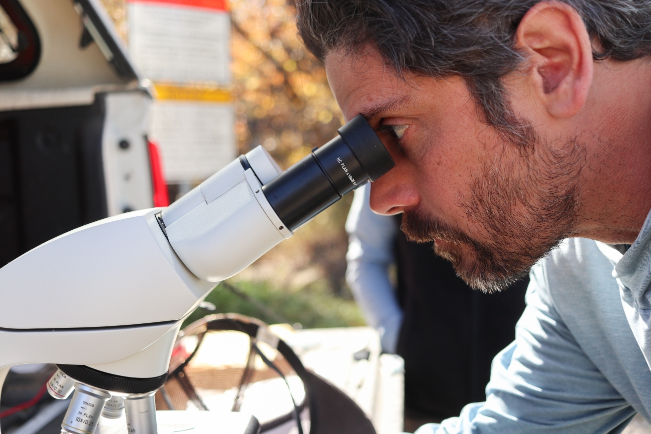 Close-up of Jay Mays at a microscope | FWS.gov